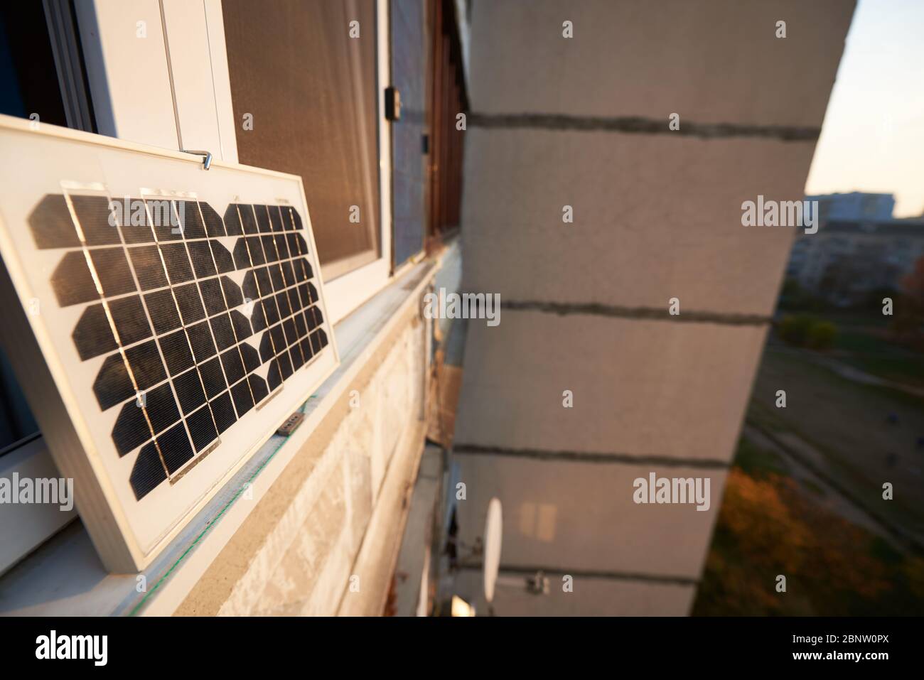 Solar panel on the window of a high-rise residential building against a ...