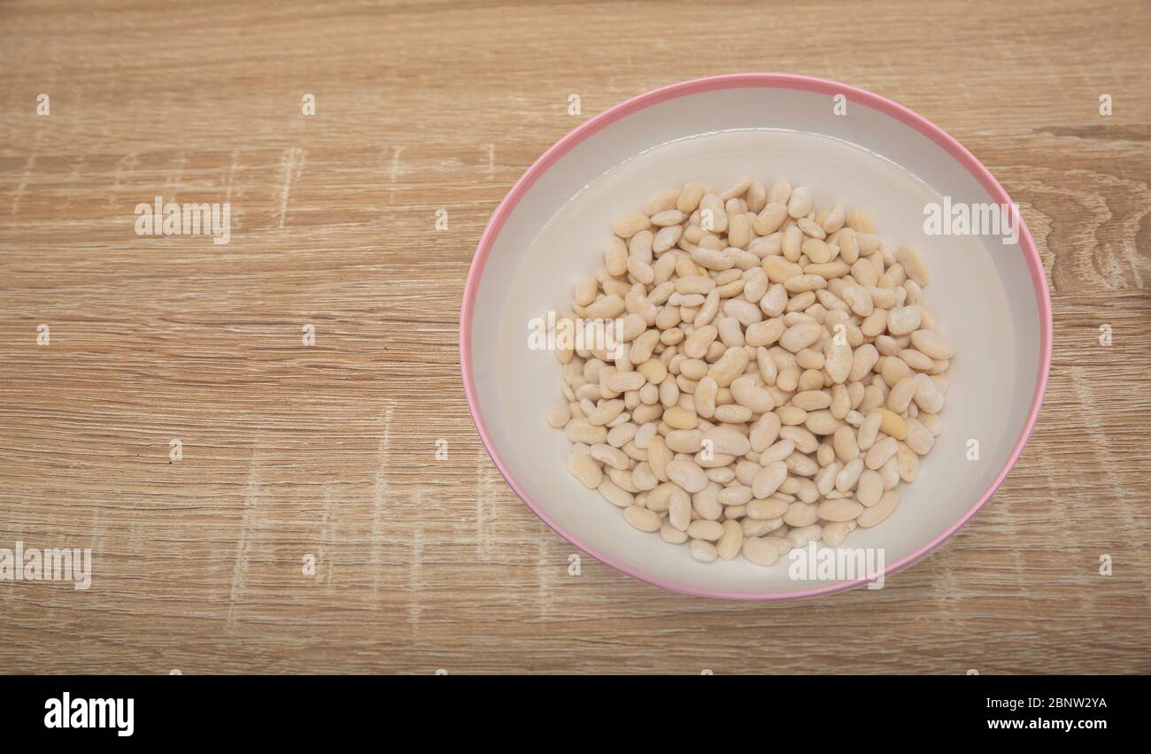 White beans in water on isolated white background Stock Photo - Alamy