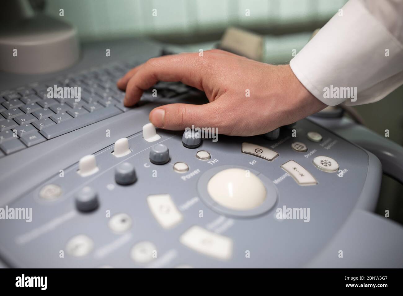 Close up shot of technician operating an ultrasound machine at a clinic ...