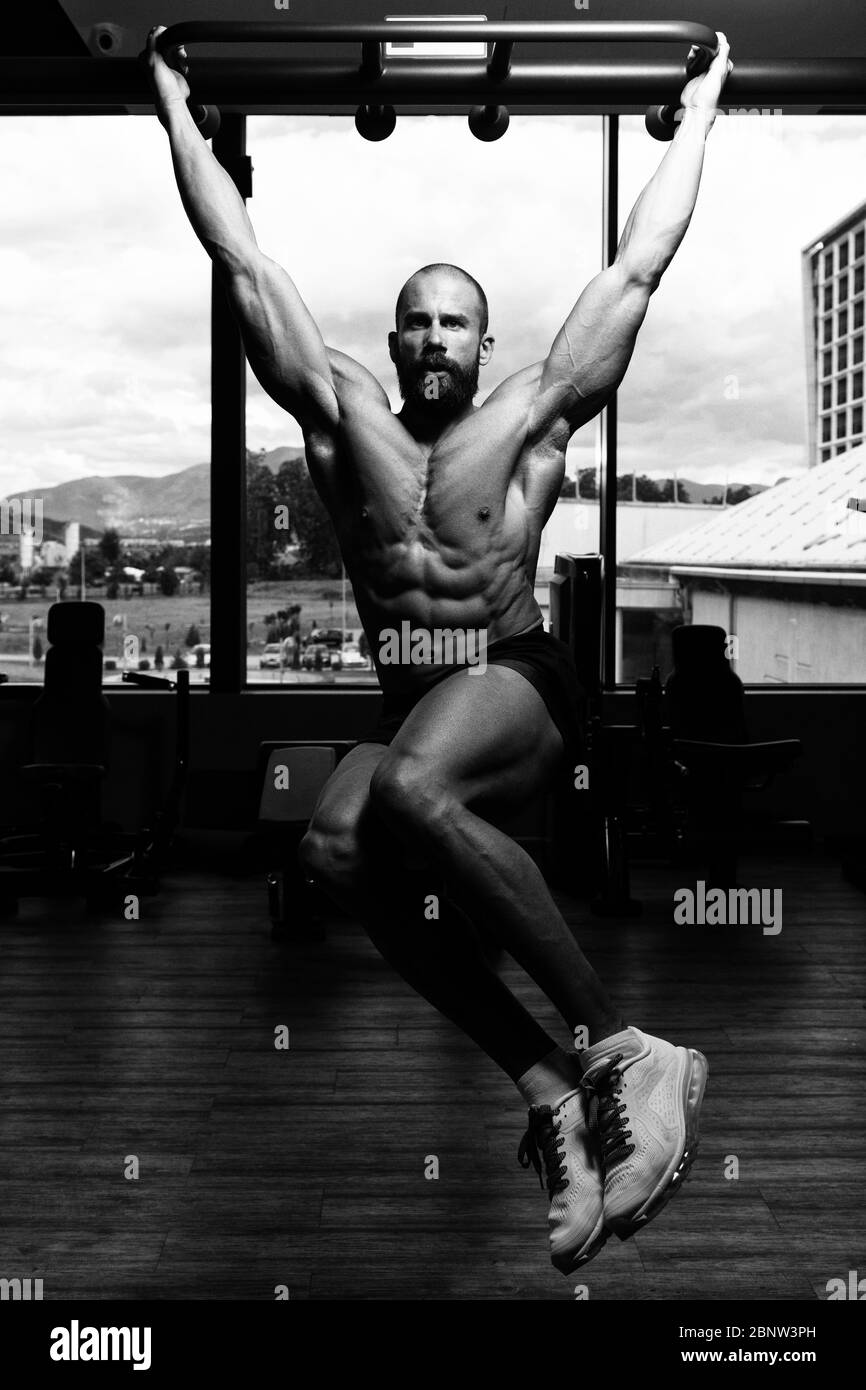 Man Performing Hanging Leg Raises Exercise - One Of The Most Effective ...