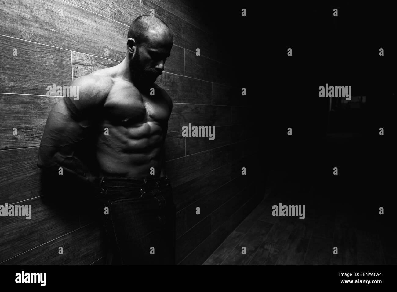 Healthy Young Man Standing Strong Standing Against a Wall and Flexing ...