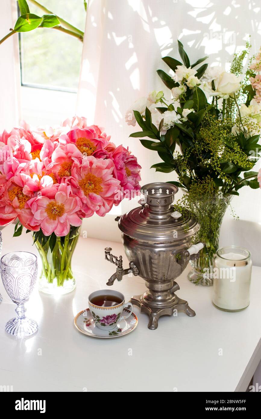 Still life with old russian samovar, rustic cup of tea, bouquet with ...