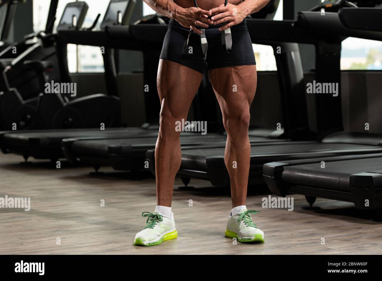 Healthy Young Man Standing Strong in the Gym and Flexing Legs Close Up ...