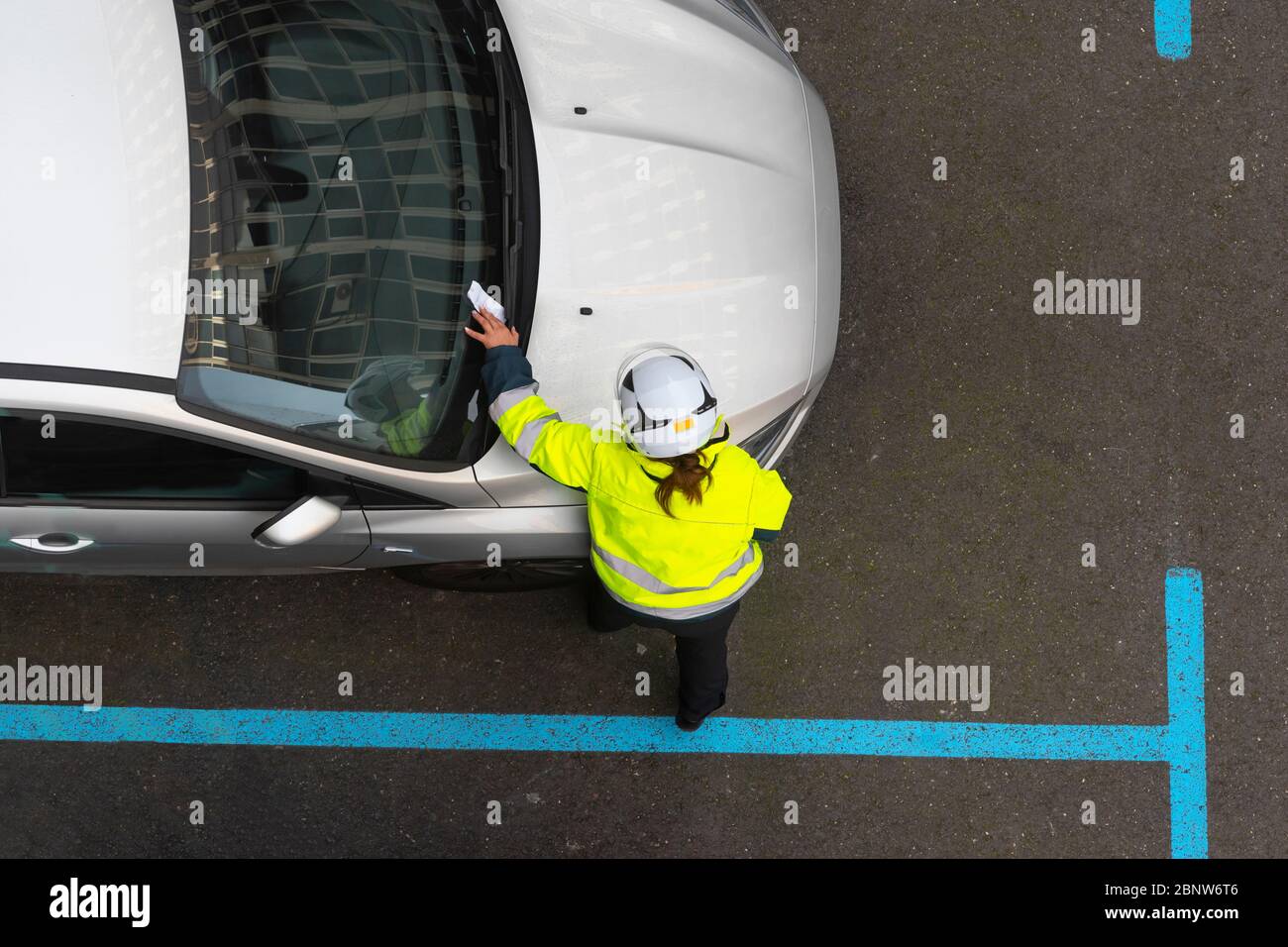 Agent putting a fine or police fining Stock Photo - Alamy