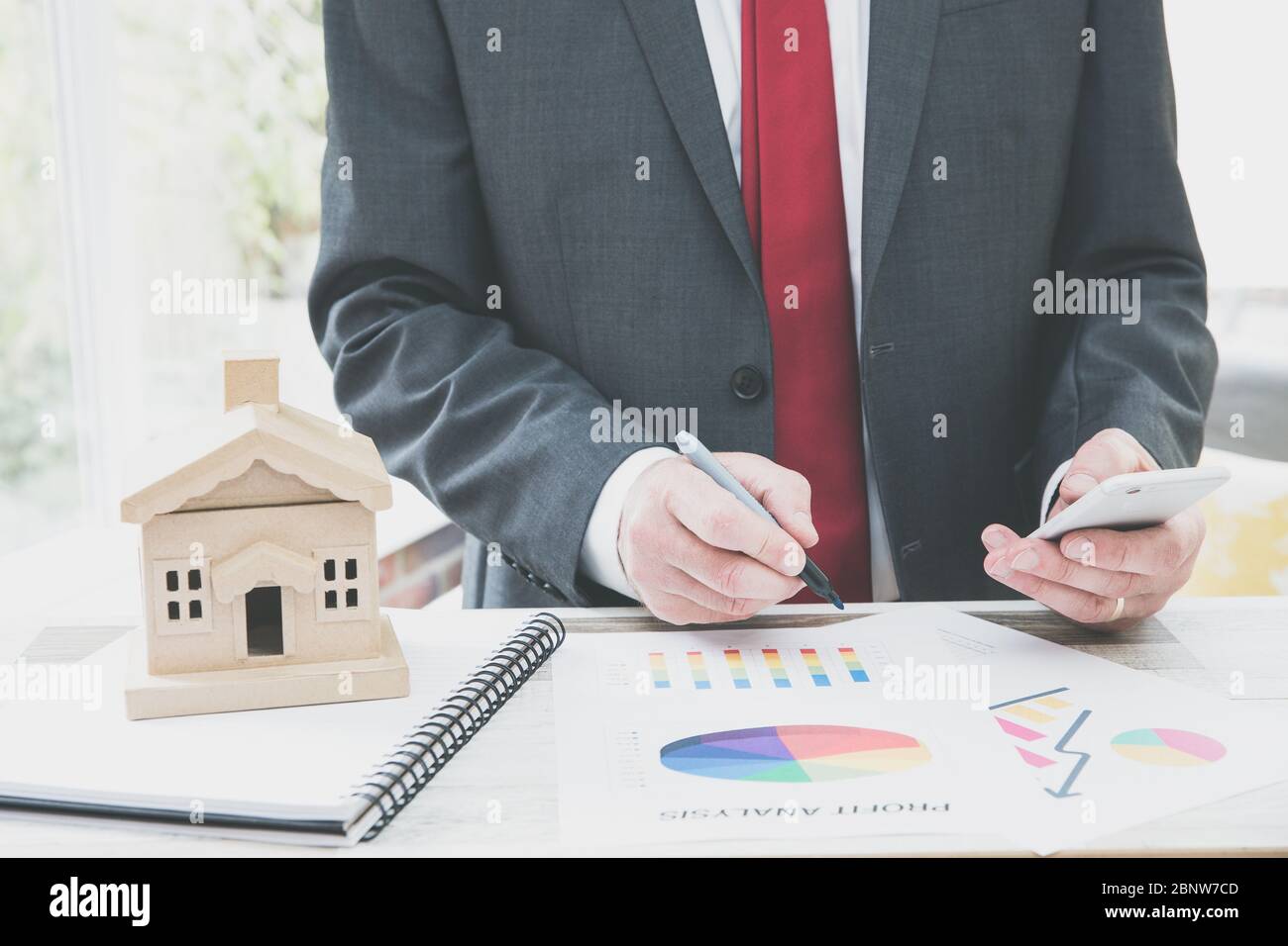 A property developer or real estate agent working at his desk and ...