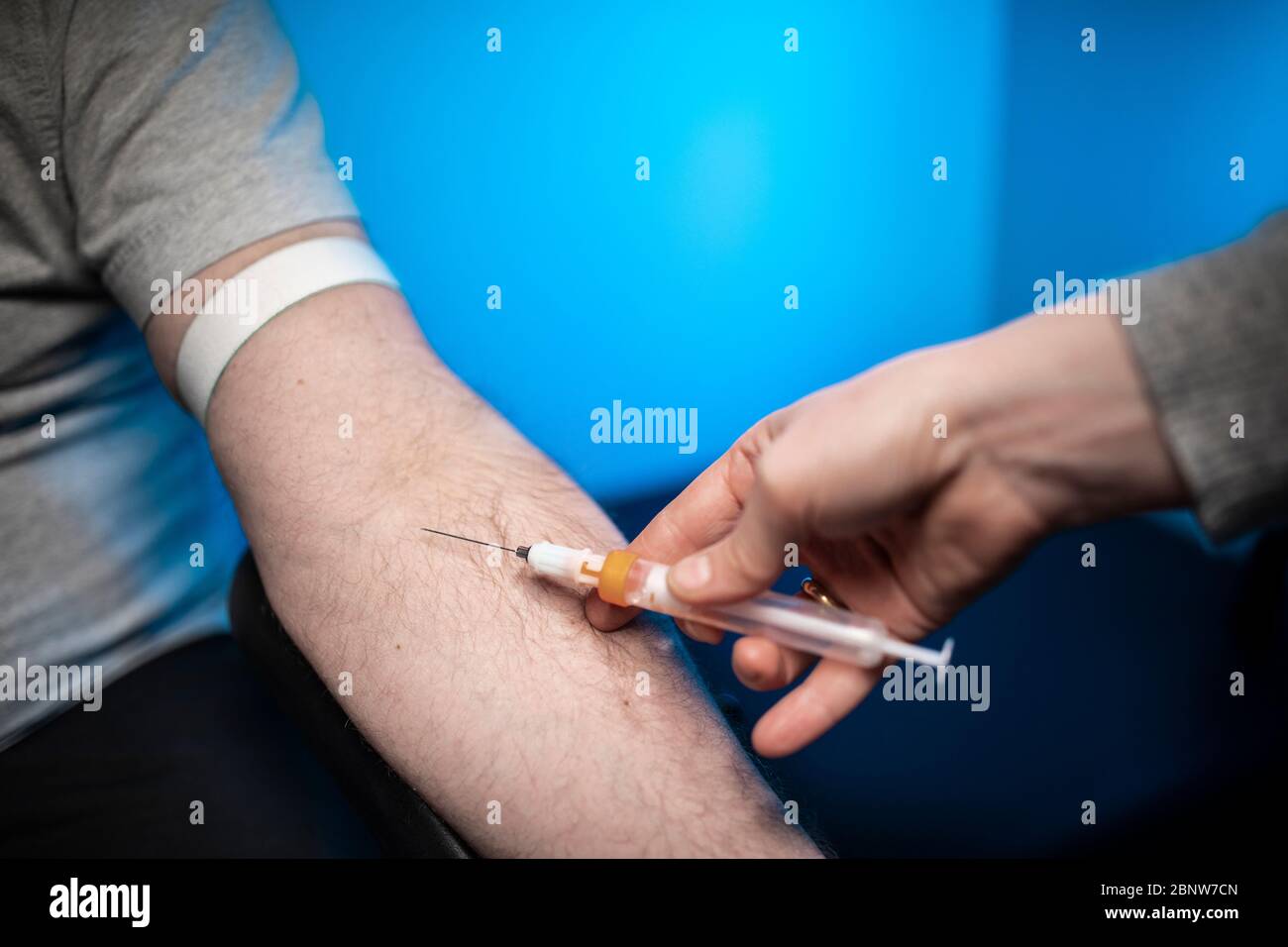 A nurse is inserting a syringe to a patient's vain Stock Photo - Alamy
