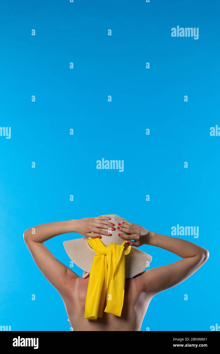 The woman's hands hold the big hat on her head Stock Photo - Alamy