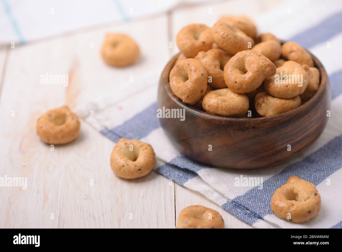 Traditional italian tarallini snack in wooden bowl Stock Photo - Alamy