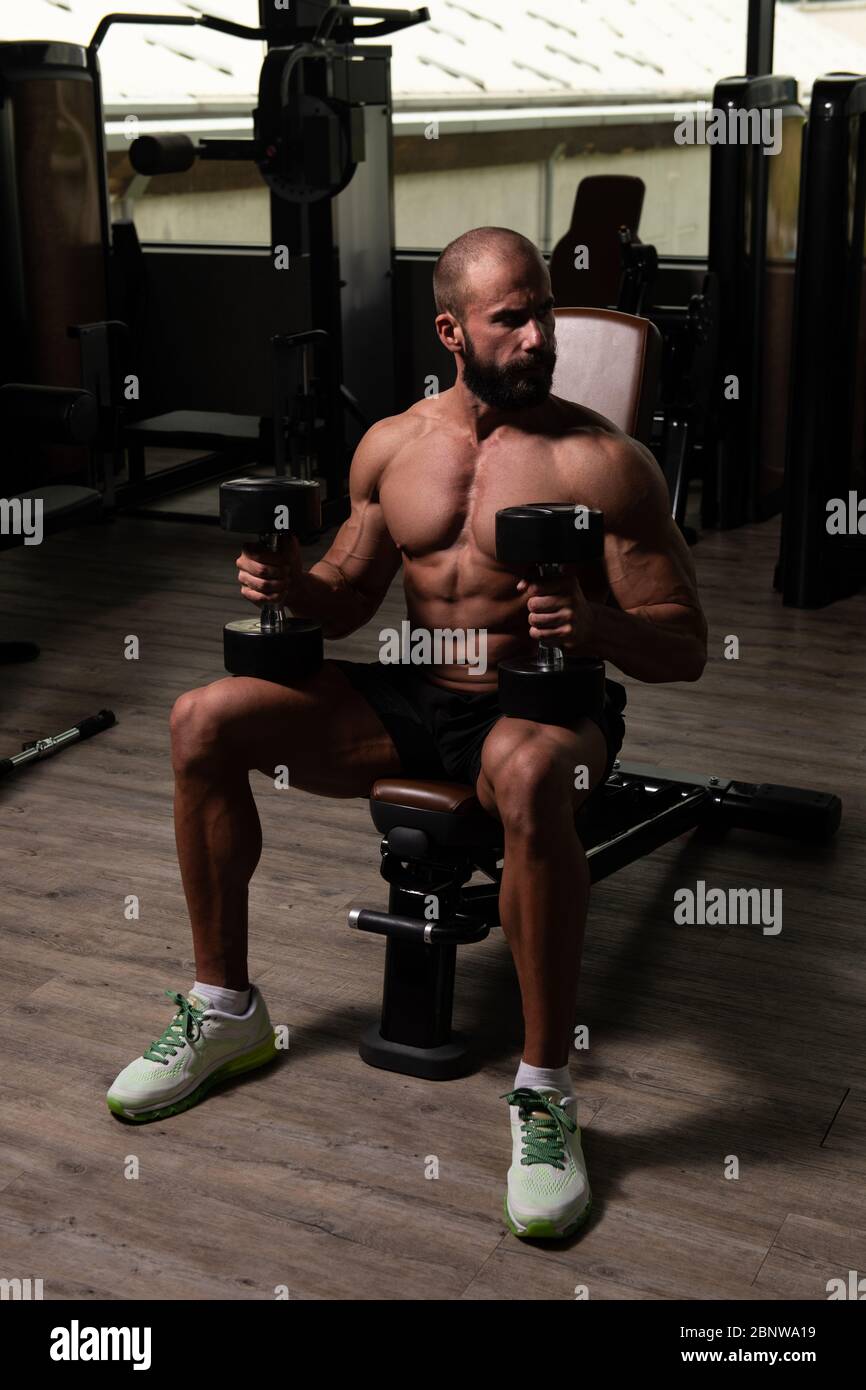 Man exercise muscles shoulders sitting hi-res stock photography and ...