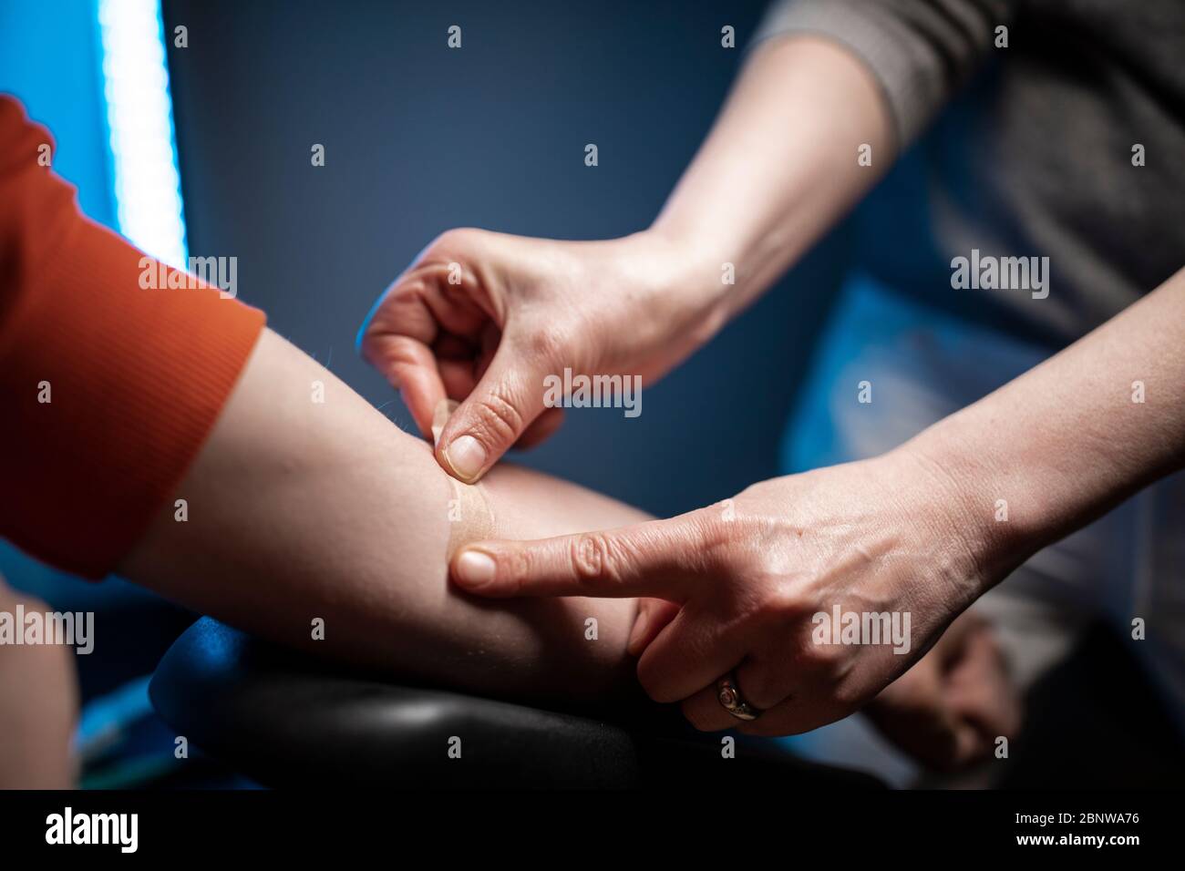 A nurse is inserting a syringe to a patient's vain Stock Photo - Alamy