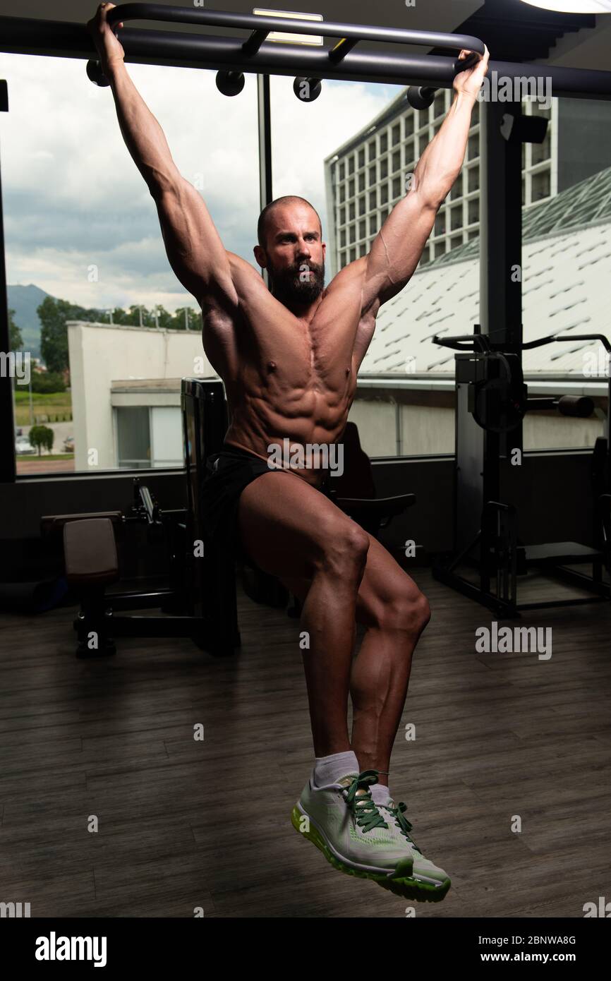 Man Performing Hanging Leg Raises Exercise - One Of The Most Effective ...