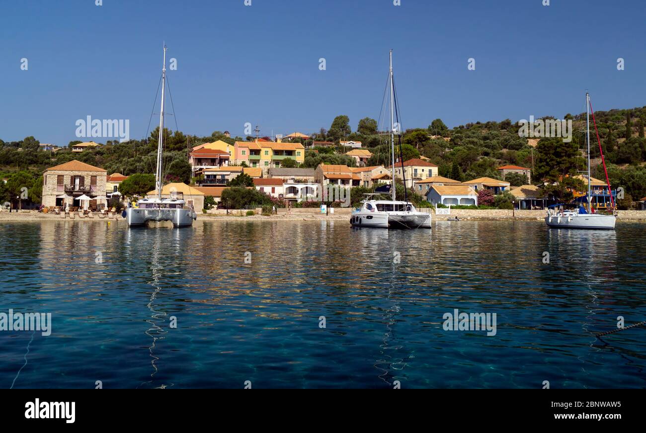 Catamarans and yachts moored at the beautiful Greek village of Kastos ...