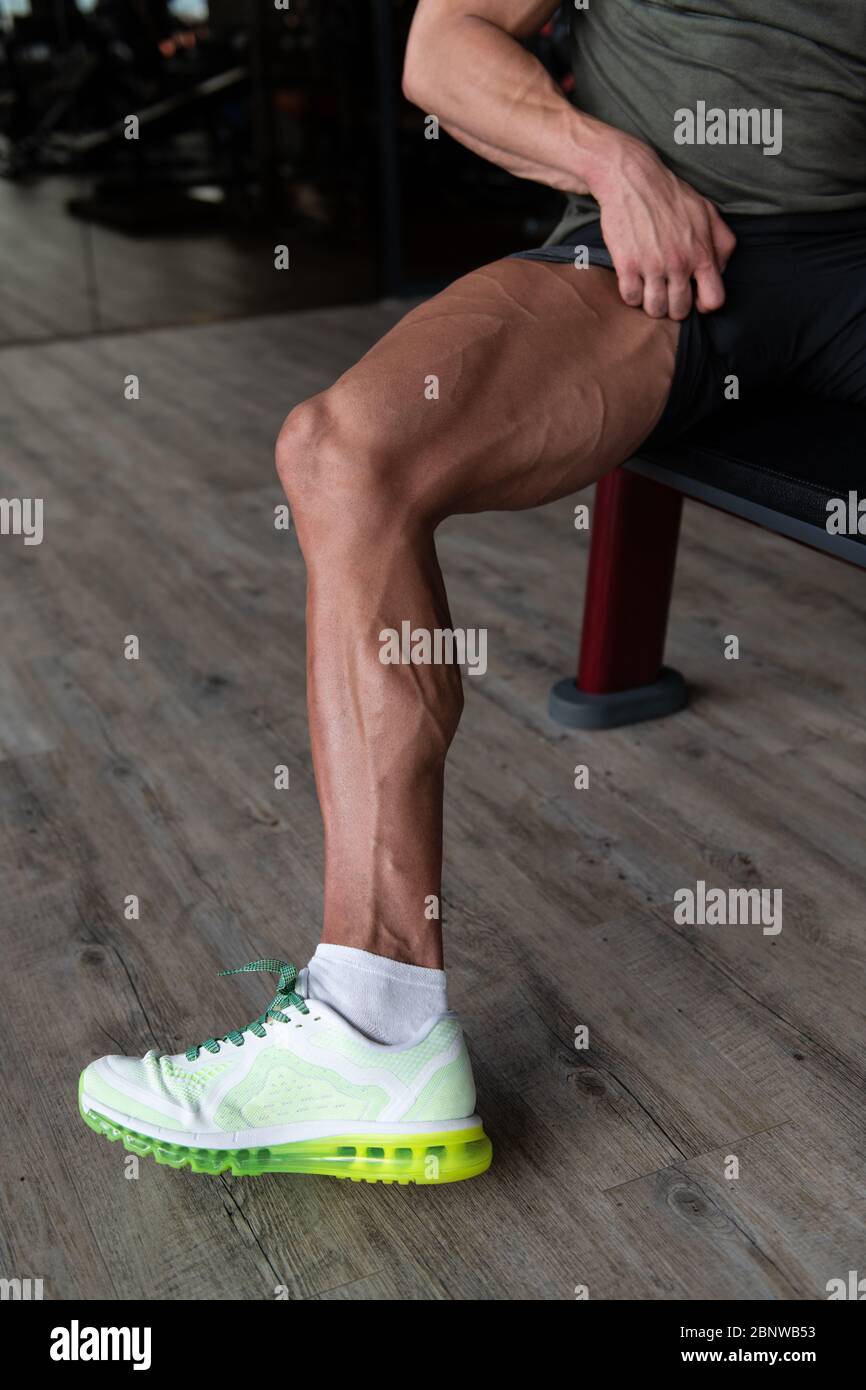Healthy Young Man Standing Strong in the Gym and Flexing Legs Close Up ...