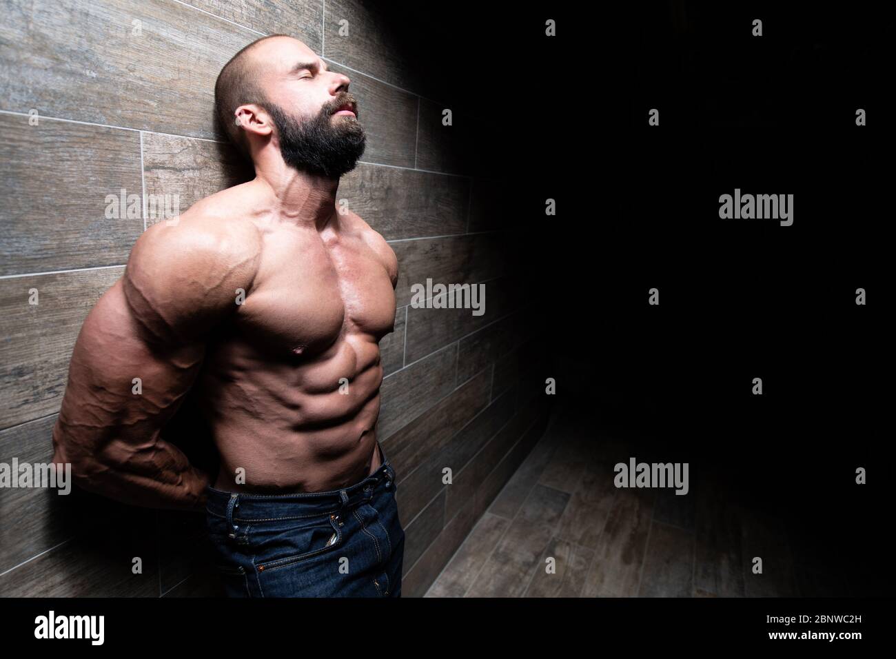Healthy Young Man Standing Strong Standing Against a Wall and Flexing ...