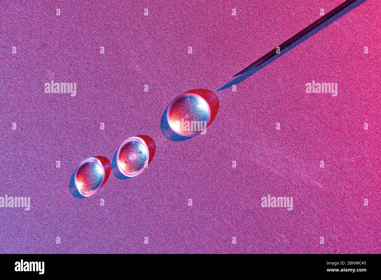 Medical needle with a drop. Colored background with liquid substance ...