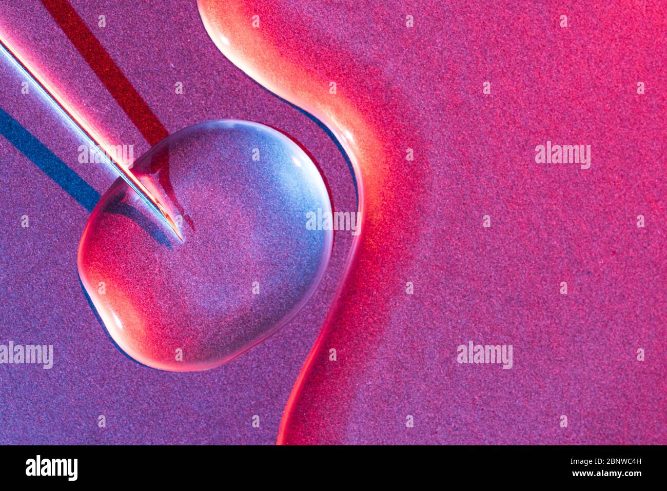 Medical needle with a drop. Colored background with liquid substance ...