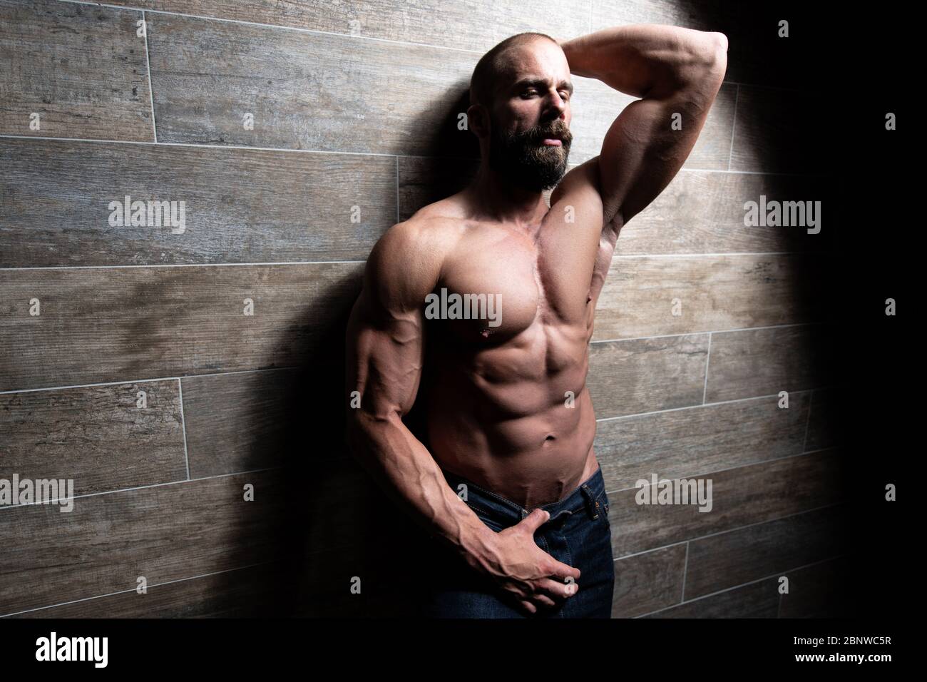 Healthy Young Man Standing Strong Standing Against a Wall and Flexing ...