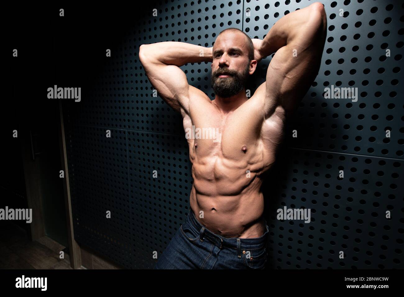 Healthy Young Man Standing Strong Standing Against a Wall and Flexing ...