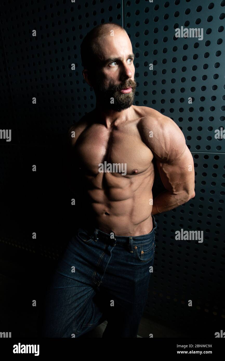 Healthy Young Man Standing Strong Standing Against a Wall and Flexing ...