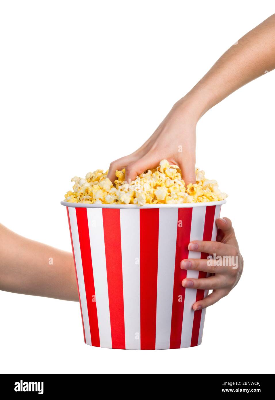 Woman hand taking popcorn from striped bucket isolated on white ...