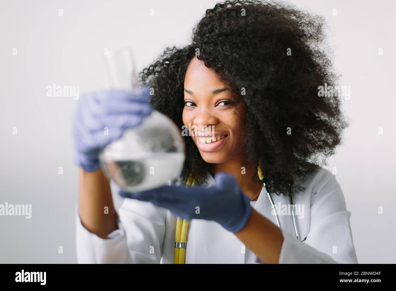 Young beautiful African American girl female with glass equipment in ...
