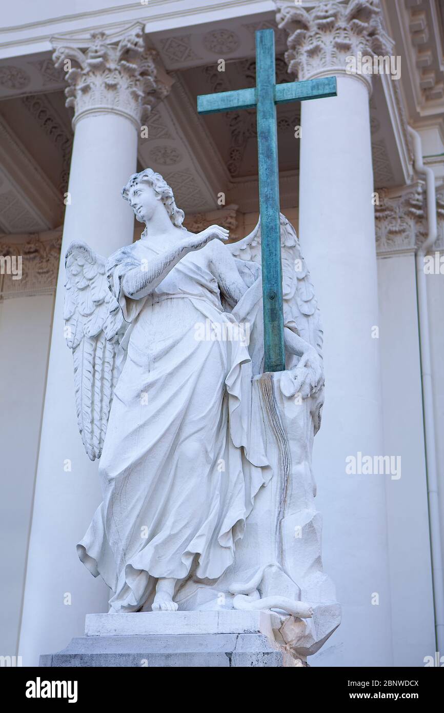 sculpture of angel with cross Stock Photo - Alamy