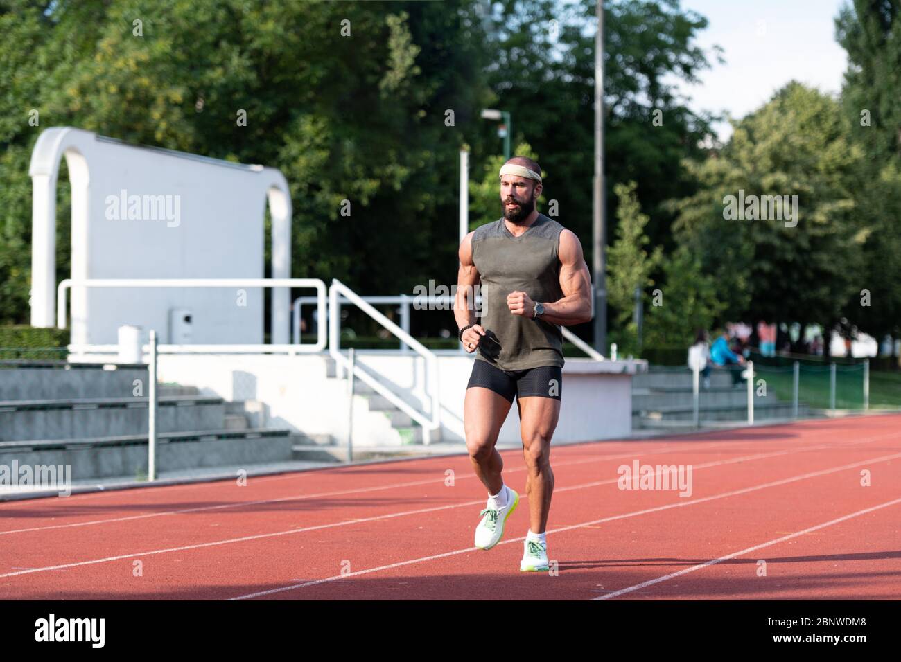 Young Athlete Man Running on Track In Park Run Athletics Race Stock ...
