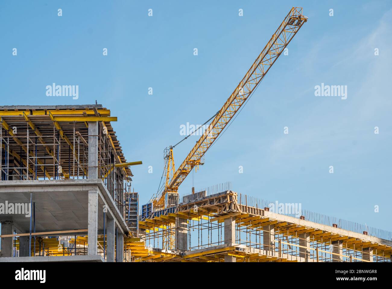 Construction crane near new built house. Construction and developing ...