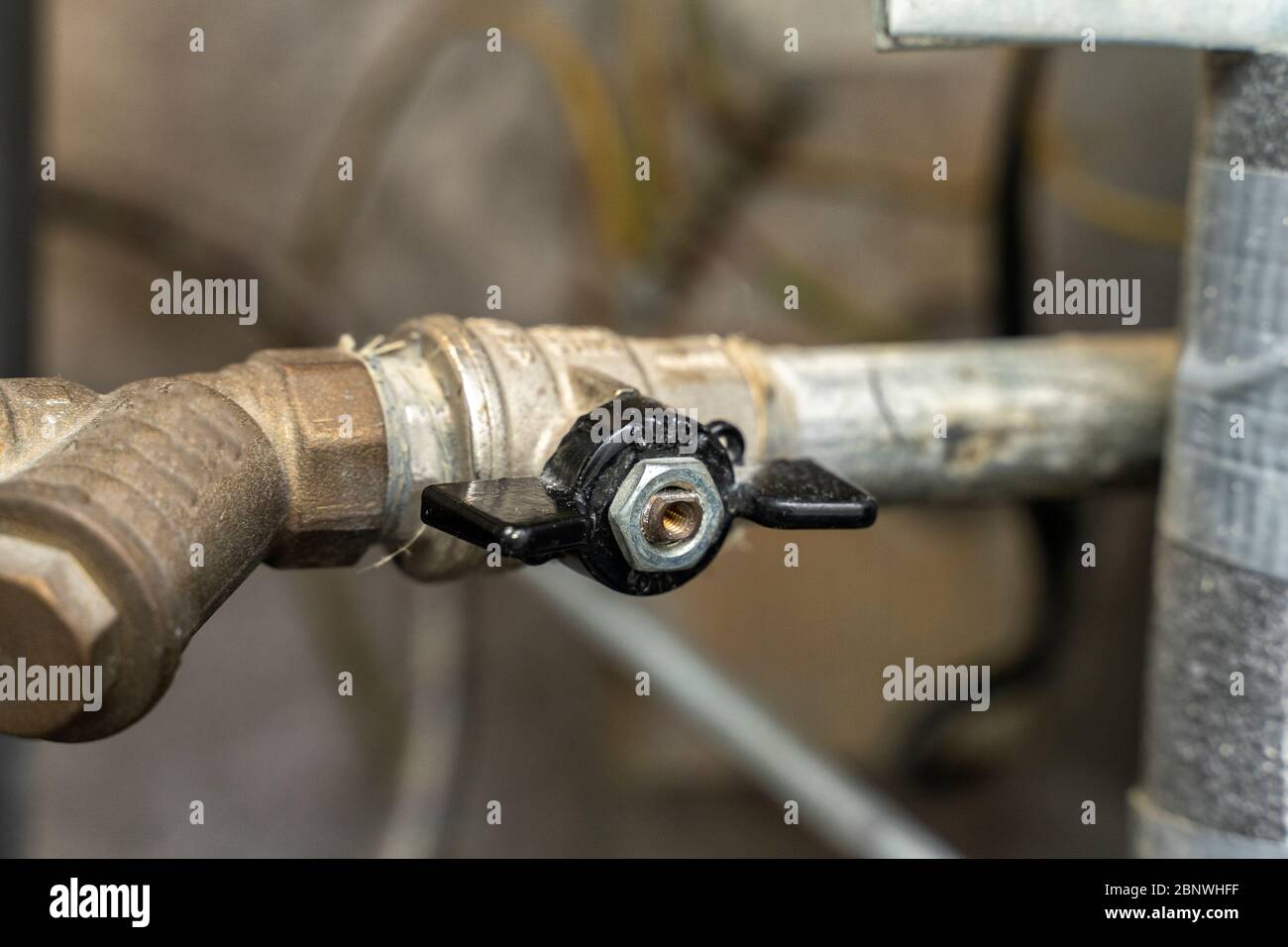 plumbing cabinet. turn off hot or cold water. Closeup of a water ...