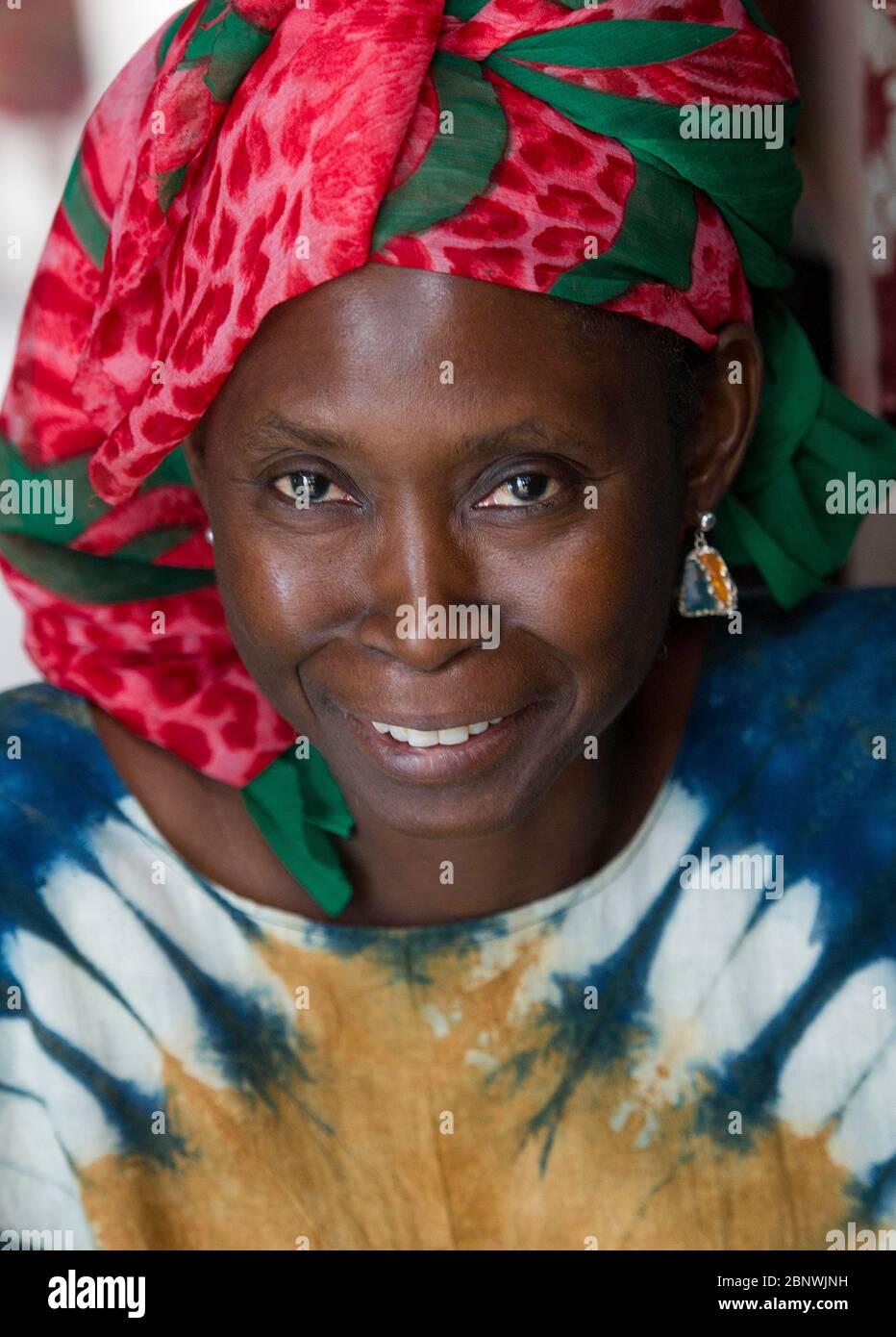 Senegalese woman poses for a picture at her fabric stall in Dakar ...