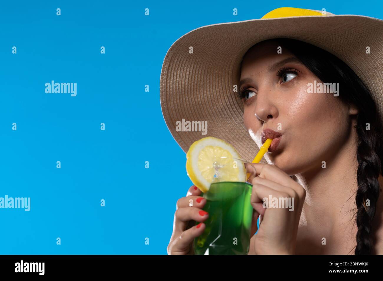 Woman sipping through straw hi-res stock photography and images - Alamy