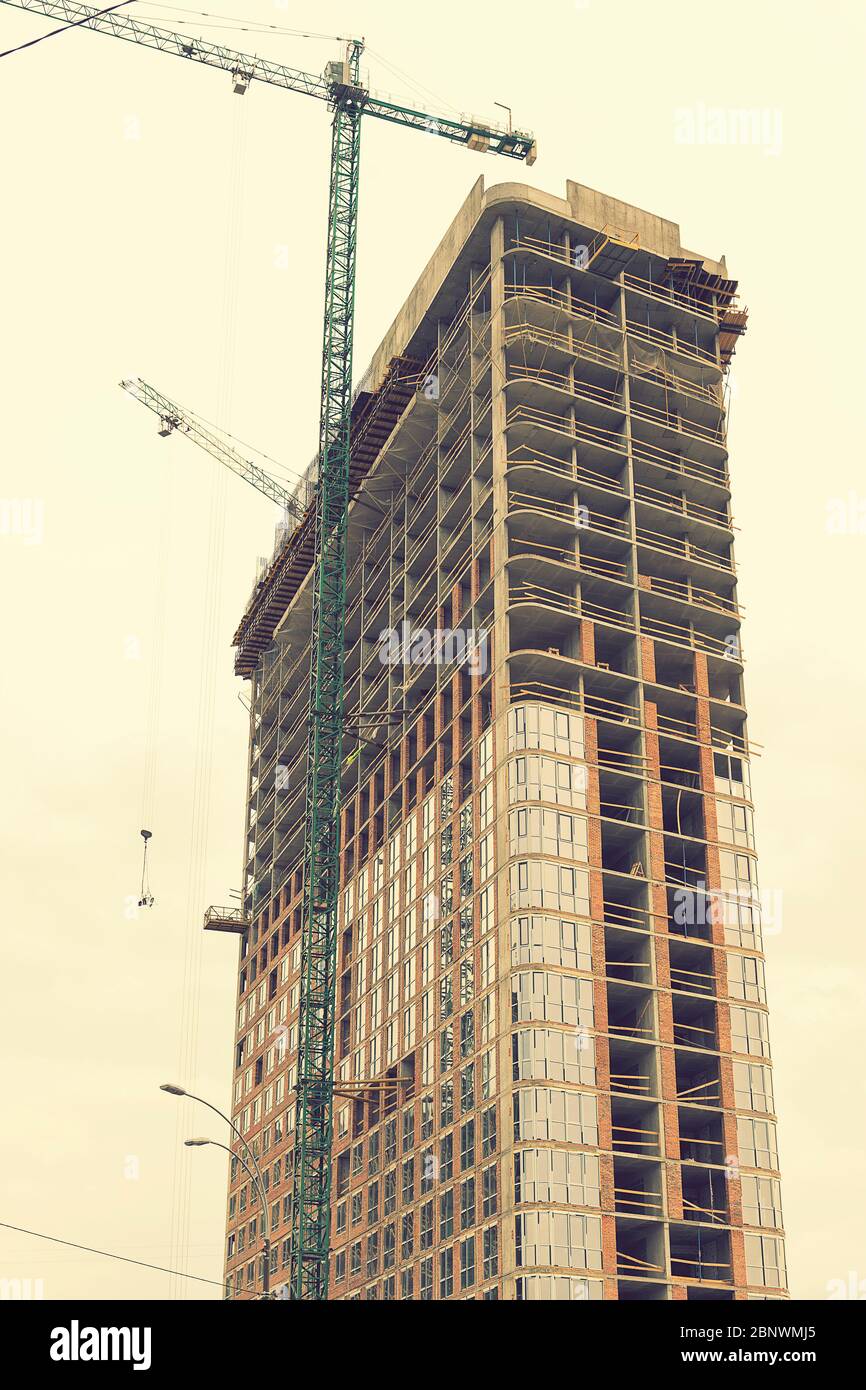 The stopped construction of a high-rise building. Unfinished floors of ...