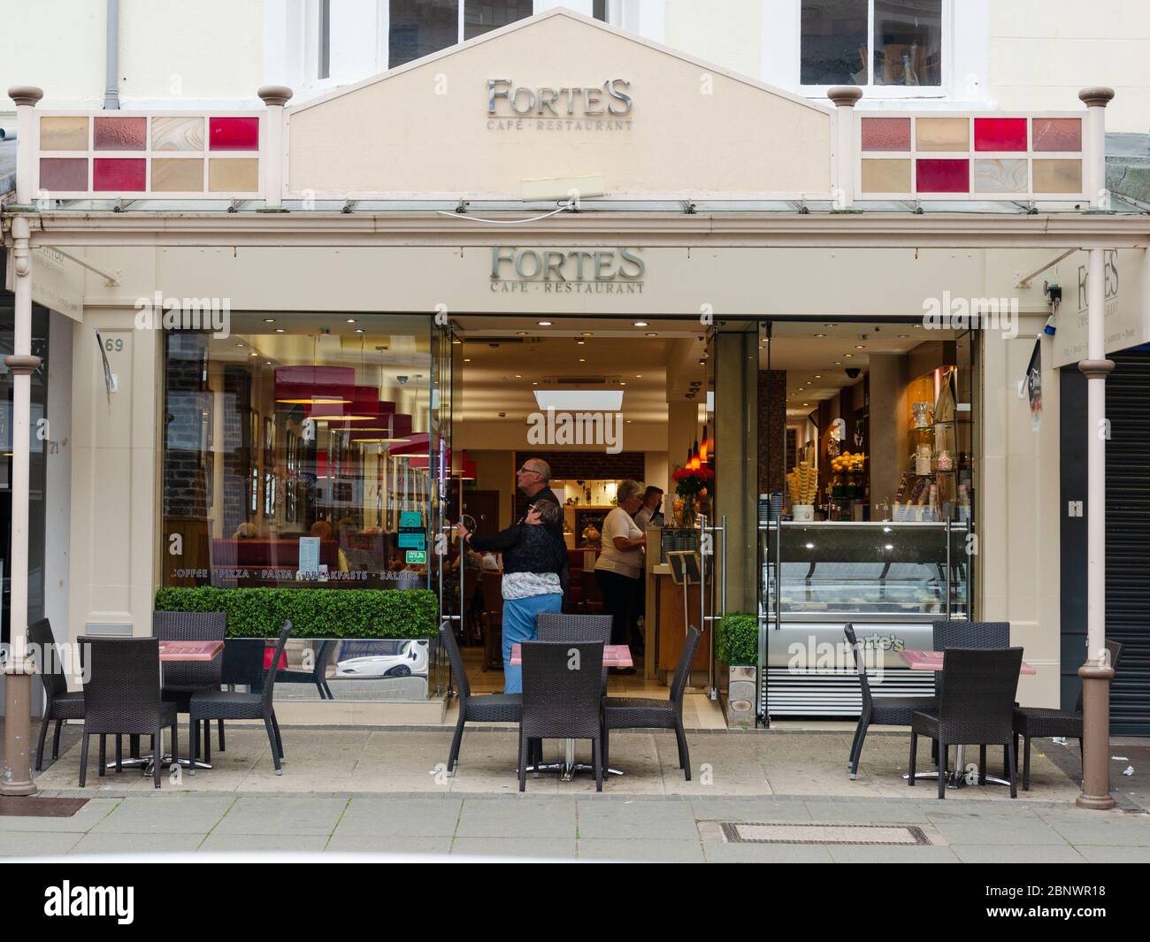 Llandudno, UK: Aug 27, 2019: A couple study the menu at Fortes ice ...