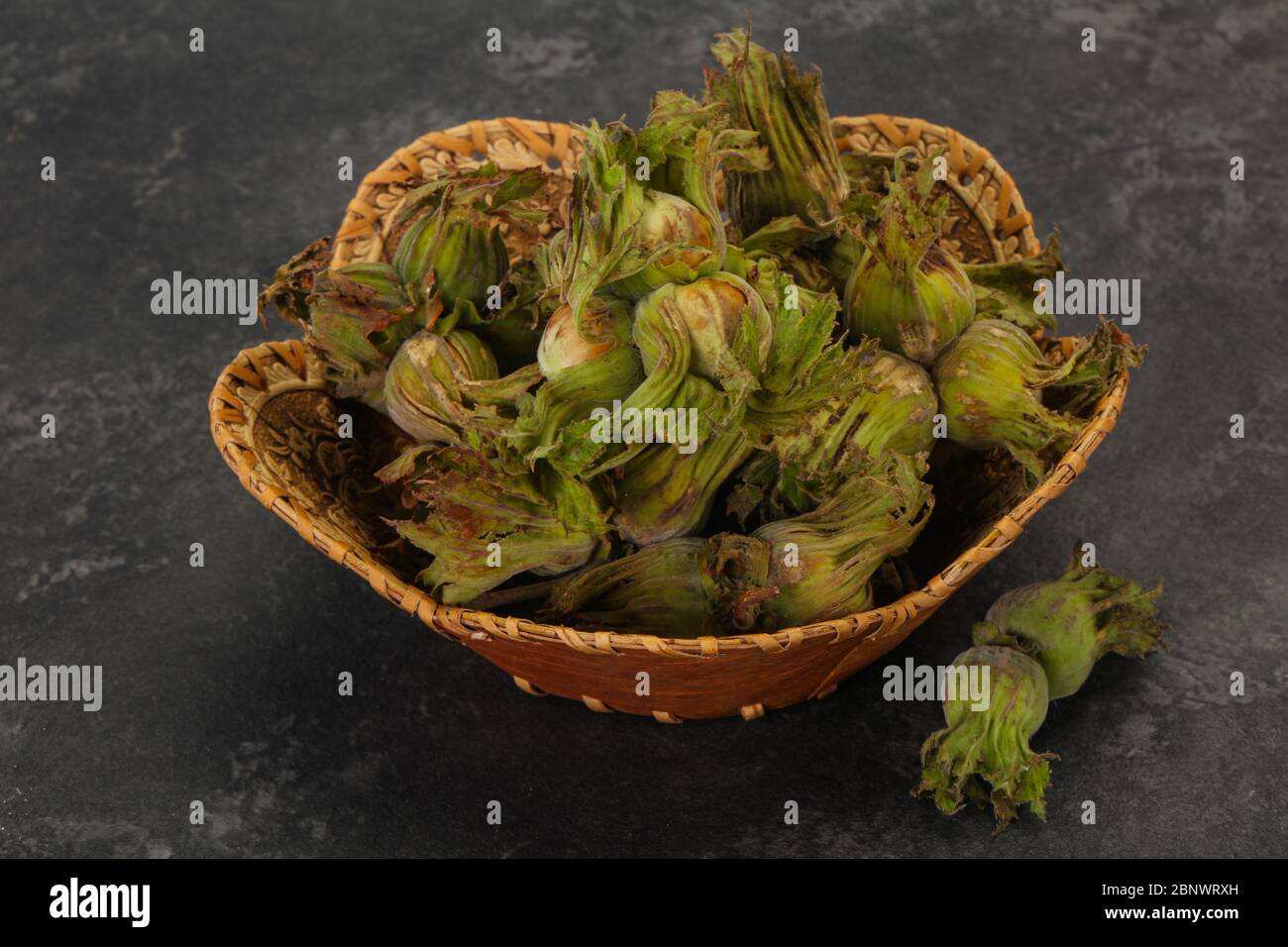Young Hazel nuts in the basket Stock Photo - Alamy