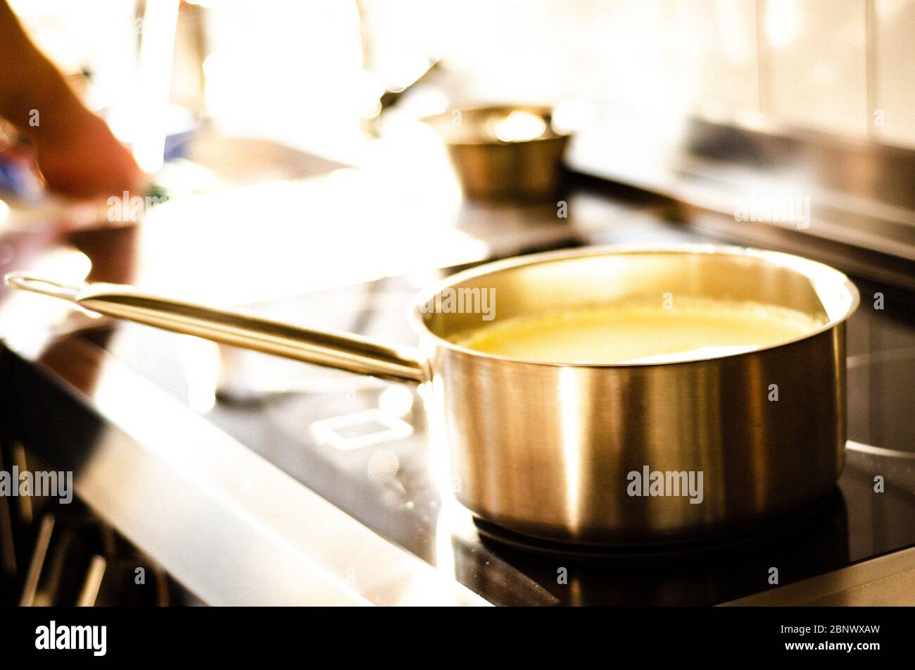 cooking vanilla cream in a saucepan on the electric stove Stock Photo ...