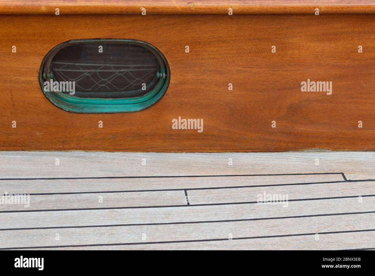 Oval ships porthole window by the deck of a sailboat, screen and ...