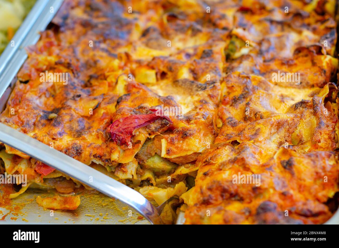 vegetable lasagna in container holding hot water into which Stock Photo ...