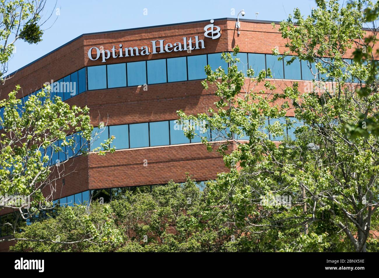A logo sign outside of the headquarters of Optima Health in Virginia ...