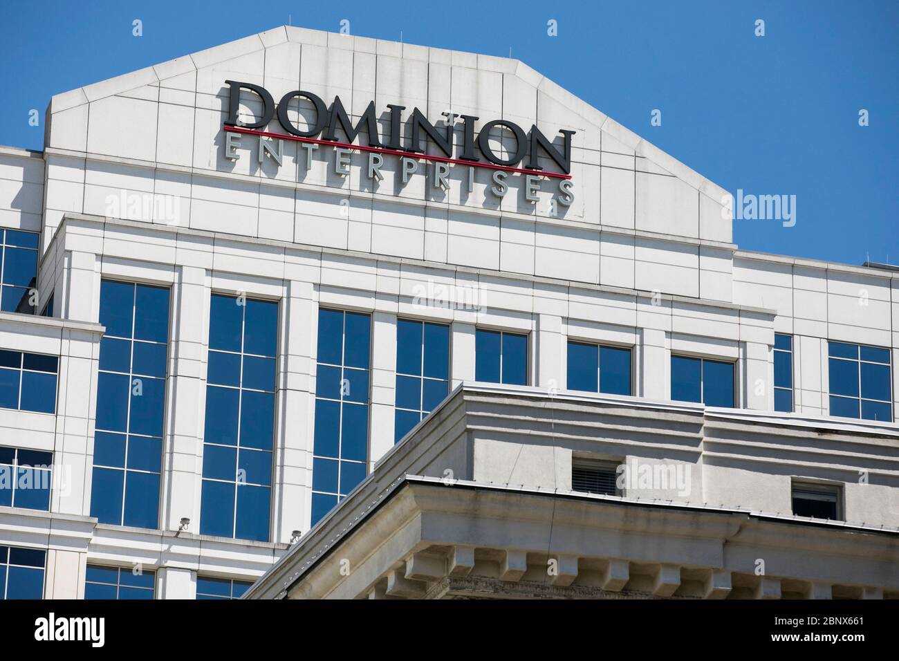 A logo sign outside of the headquarters of Dominion Enterprises in ...