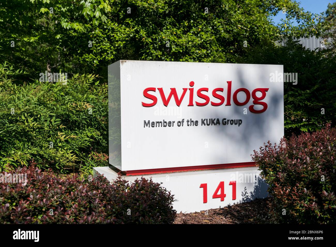 A logo sign outside of a facility occupied by Swisslog in Newport News ...