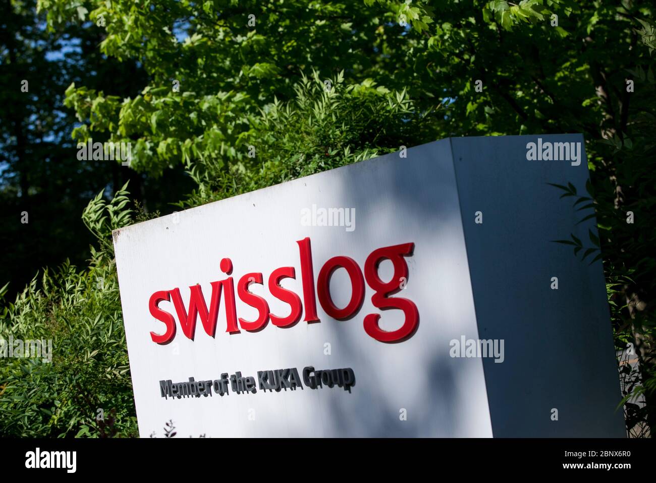 A logo sign outside of a facility occupied by Swisslog in Newport News ...