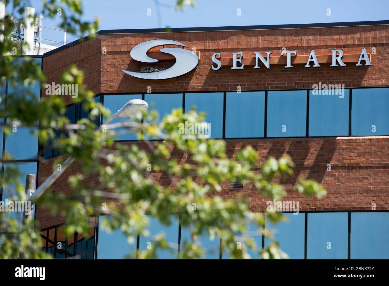 A logo sign outside of a facility occupied by Sentara Healthcare in ...