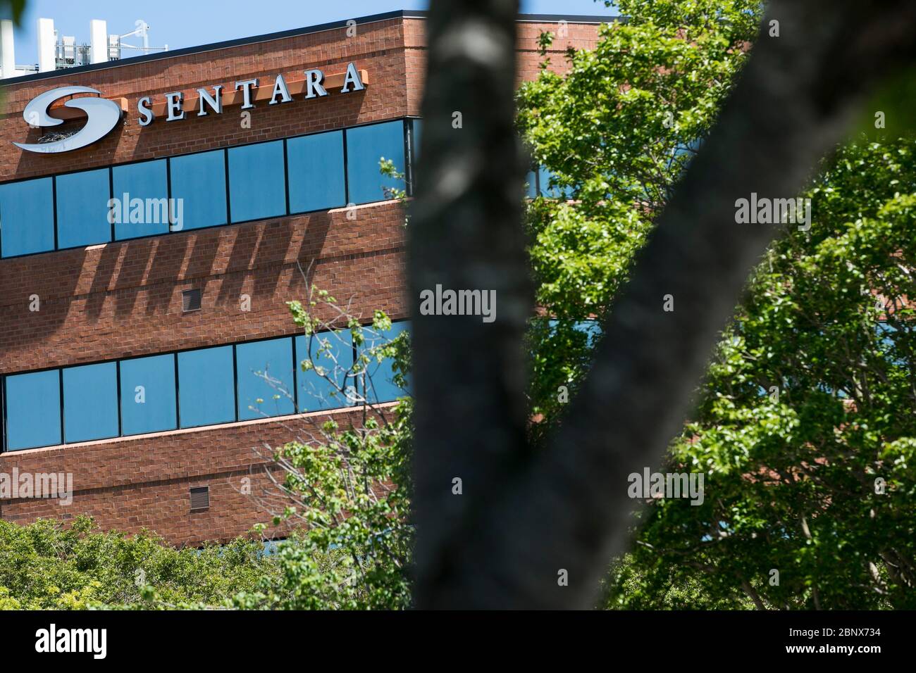 A logo sign outside of a facility occupied by Sentara Healthcare in ...