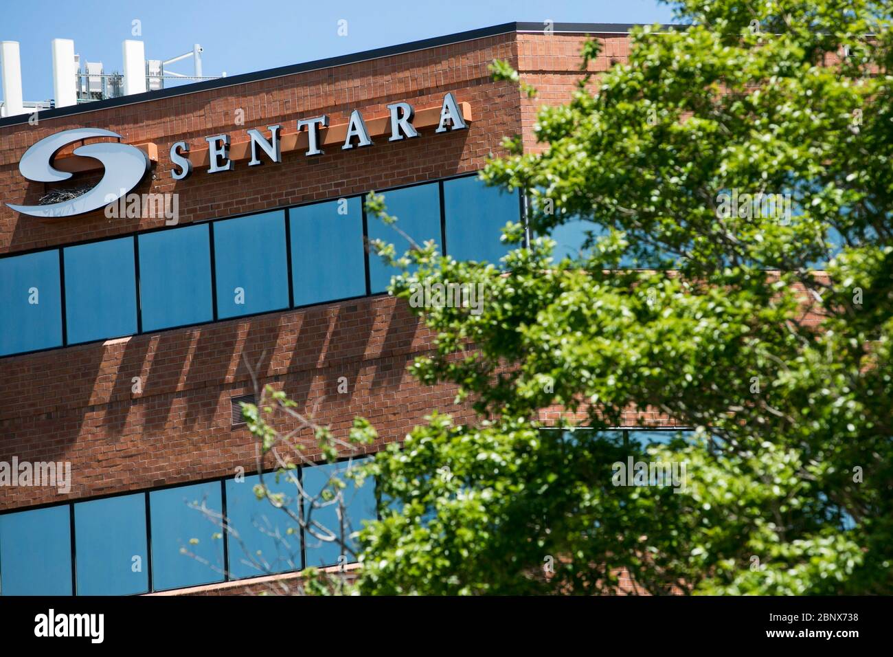 A logo sign outside of a facility occupied by Sentara Healthcare in ...
