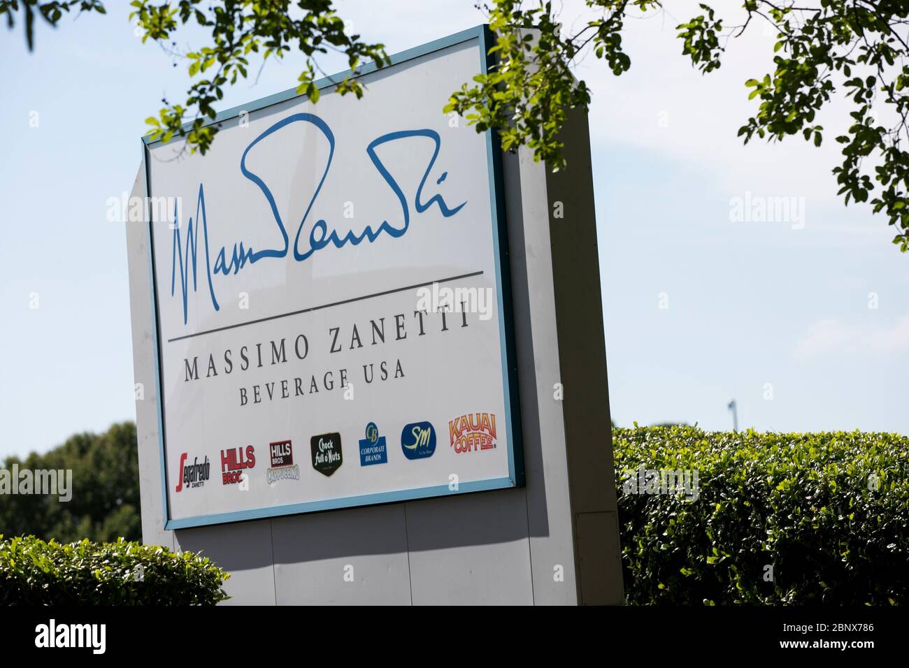 A logo sign outside of a facility occupied by the Massimo Zanetti ...