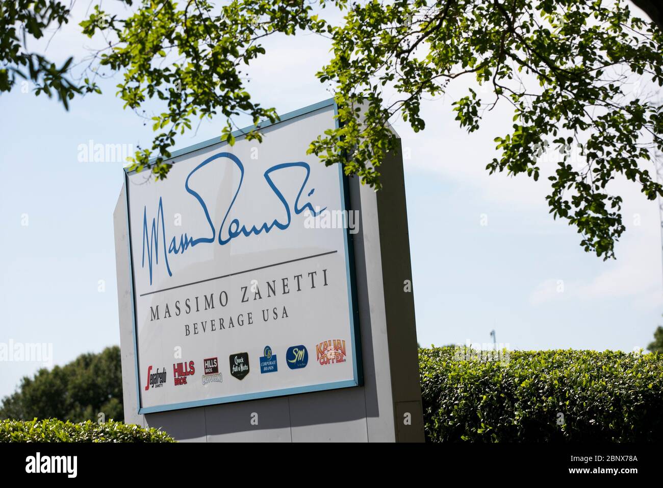A logo sign outside of a facility occupied by the Massimo Zanetti ...