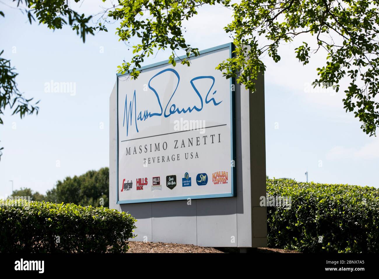 A logo sign outside of a facility occupied by the Massimo Zanetti ...