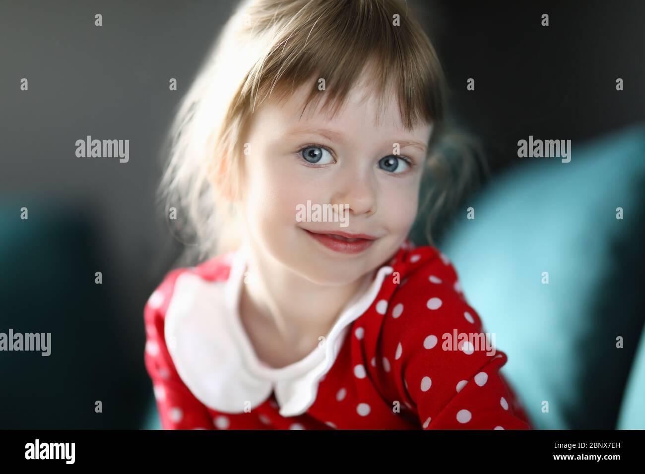 Happy child girl portrait against home Stock Photo - Alamy