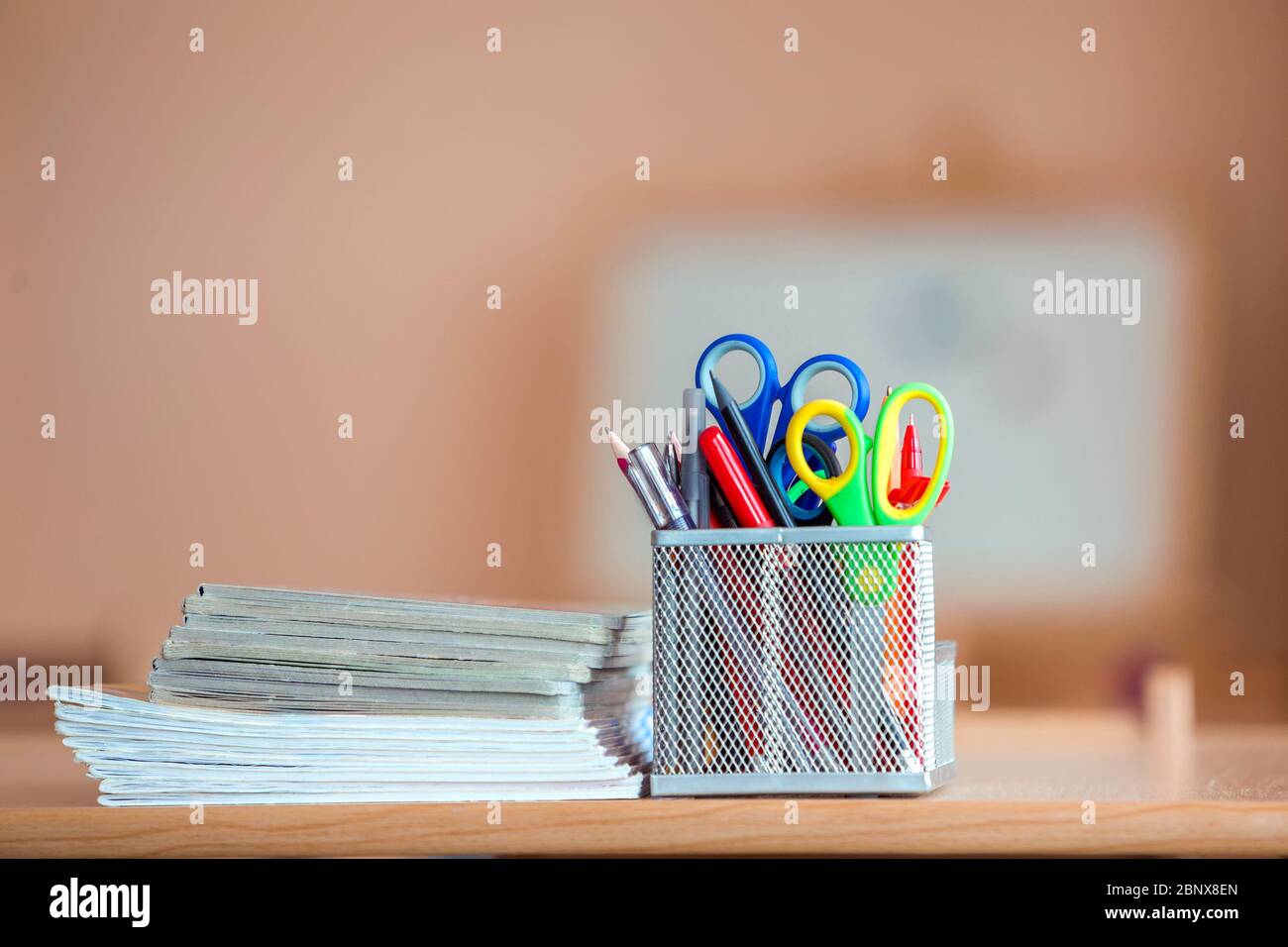Stack of notebooks and stationery arrangement in classroom or office on ...