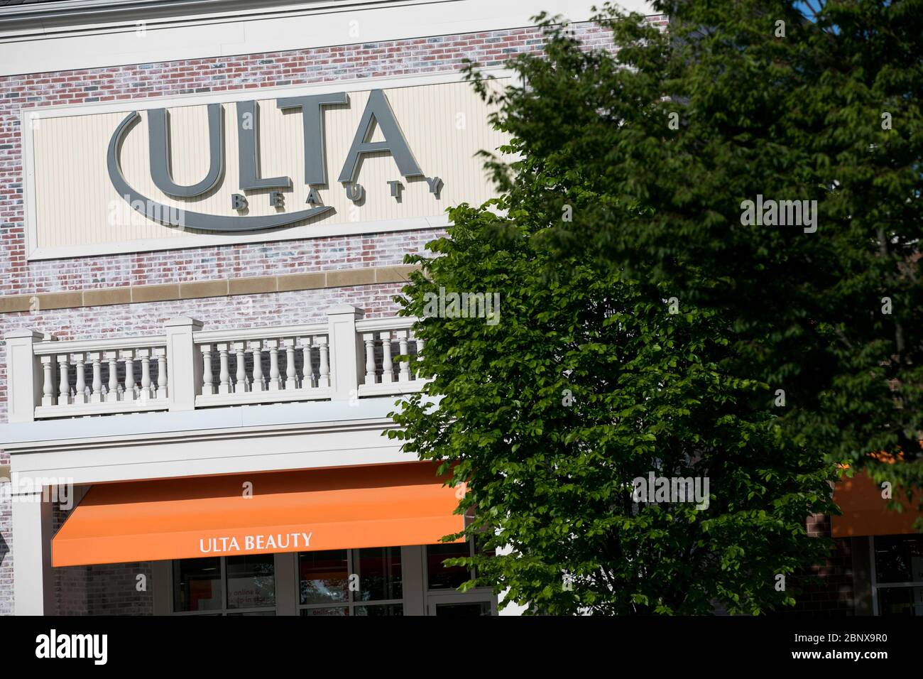A logo sign outside of a Ulta Beauty retail store location in ...